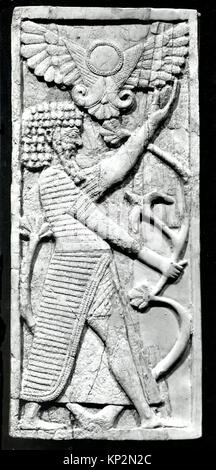 Male figure grasping a tree winged sun disc above Neo Assyrian 9-8th ...