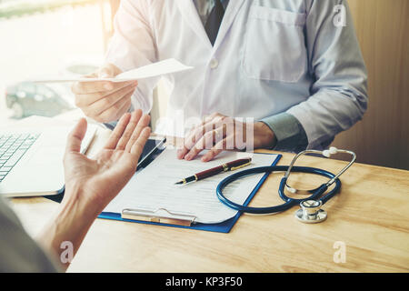Doctor or physician writing diagnosis and giving a medical prescription ...