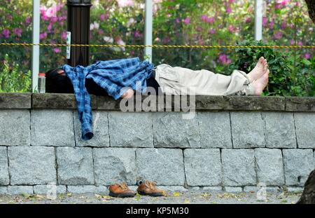 A homeless man in Tokyo, Japan. Homelessness is a common sight on the ...