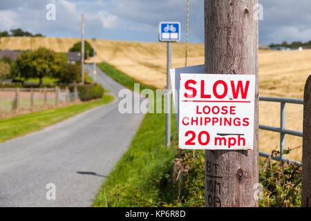 Loose chippings warning sign Stock Photo - Alamy