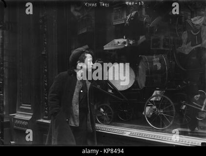 Poor boy early 20th century 1910s looking at store window display in ...