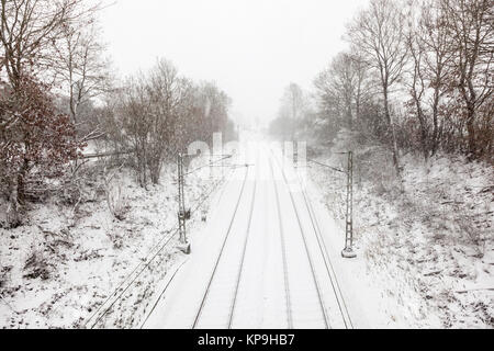 snow covered railroad track during snowfall in winter Stock Photo - Alamy