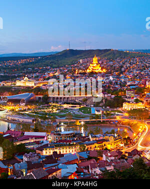 An aerial view of the beautiful illuminated Tbilisi city at soft ...