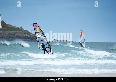 Men windsurfing waves in Gwithian, Cornwall, UK Stock Photo - Alamy
