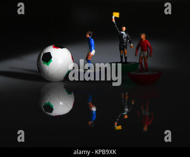 Offside rule shown with Subbuteo players and linesman Stock Photo - Alamy