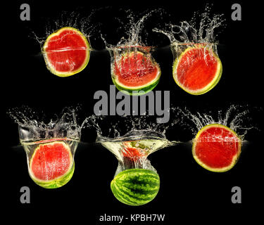 Fresh melon falling in water with splash on black Stock Photo - Alamy