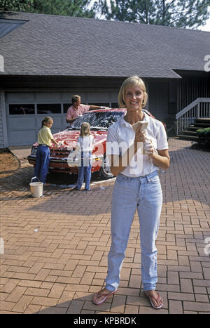 1990 HISTORICAL FAMILY WASHING AUTOMOBILE IN FRONT DRIVEWAY OF SUBURBAN ...