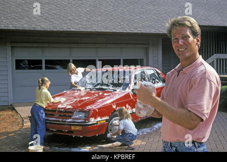 1990 HISTORICAL FAMILY WASHING AUTOMOBILE IN FRONT DRIVEWAY OF SUBURBAN ...