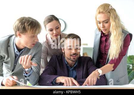 Business partners looking at flipchart paper Stock Photo - Alamy
