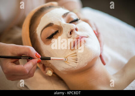 Woman gets face mask applied Stock Photo - Alamy