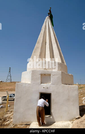 A Yazidi or Yezidi refugee man in the holy temple of Lalesh in Iraqi ...