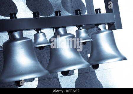 Various bells in a row Stock Photo - Alamy