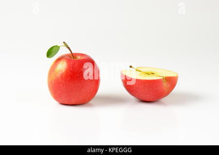 One half and one whole juicy apples, close-up, isolated on white Stock ...