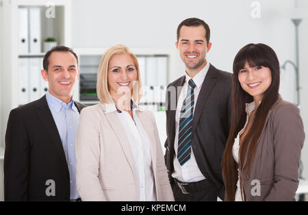 Group portrait of joyful Asian businessmen wearing elegant suits posing ...