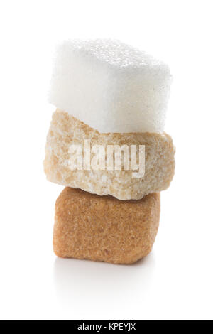 Three cubes of unrefined brown sugar stacked on top of each other on a ...