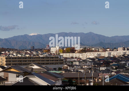 Mount Fuji seen over suburban houses and apartments buildings in ...