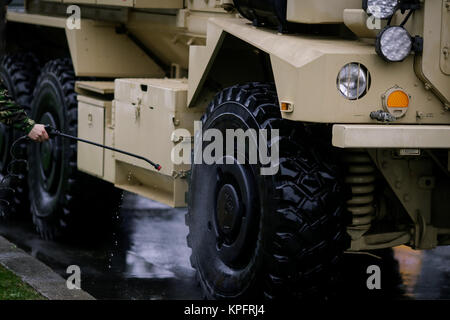 Soldier washing an armoured vehicle at a military parade Stock Photo ...