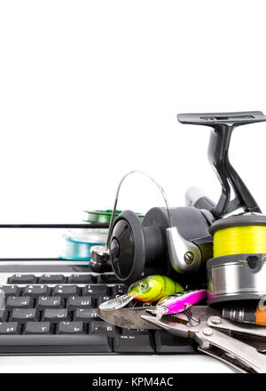 fishing tackles on computer keyboard Stock Photo - Alamy