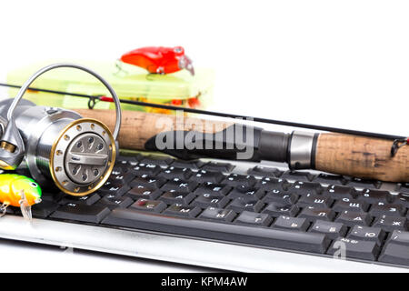 fishing tackles on computer keyboard Stock Photo - Alamy
