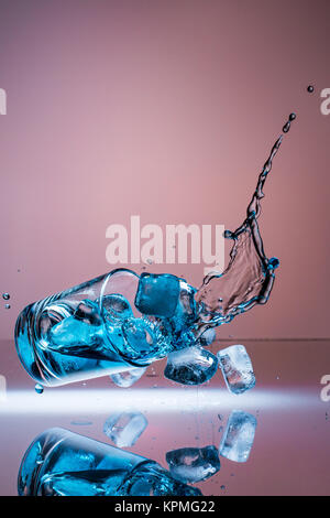 ice cube falls into water glass Stock Photo - Alamy