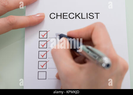 Woman Marking On Checklist Form With Red Pen Stock Photo - Alamy