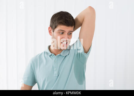 Young Man With Hyperhidrosis Pointing To A Sweat Armpit Stock Photo - Alamy