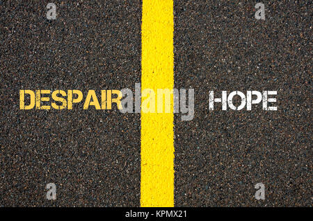 Antonym concept of DESPAIR versus HOPE written over tarmac, road ...