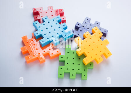 Colorful plastic jigsaw puzzle game Stock Photo - Alamy