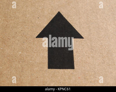Black arrow on cardboard Stock Photo - Alamy
