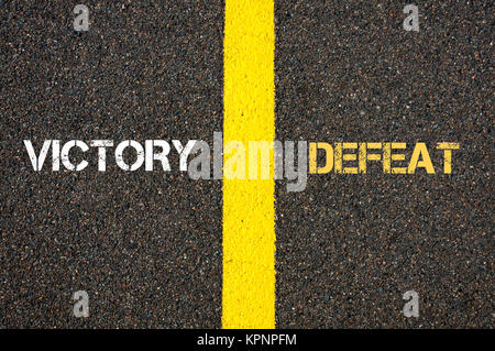Antonym concept of VICTORY versus DEFEAT written over tarmac, road ...