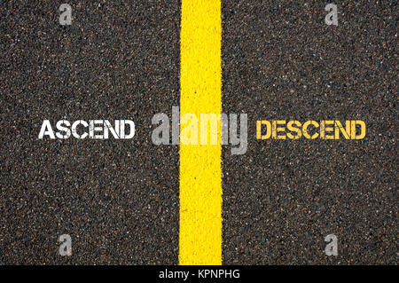Antonym concept of ASCEND versus DESCEND written over tarmac, road ...