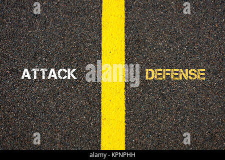 Antonym concept of ATTACK versus DEFENSE written over tarmac, road ...