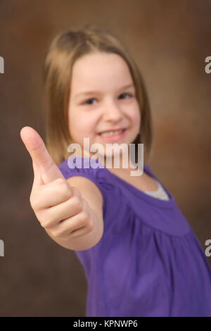 Thumbs up to being happy. Studio shot of a casual young man posing ...