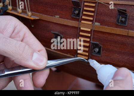 Young man constructing a ship model in a ship-modelling studio Stock ...