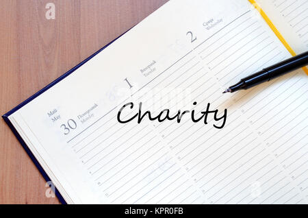 Charity write on notebook Stock Photo - Alamy
