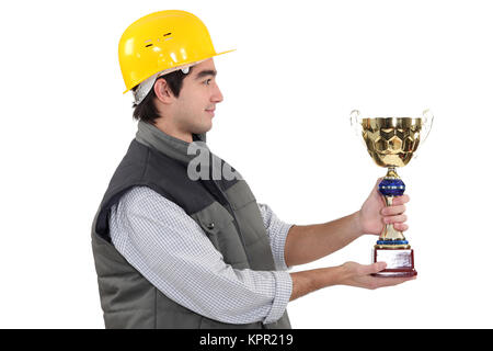 Construction worker with a trophy Stock Photo - Alamy