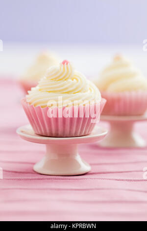 Mini Vanilla Cupcakes with Pink Buttercream Frosting Stock Photo - Alamy