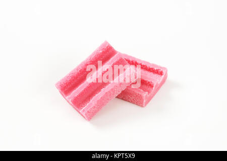 two pieces of pink chewing gum on white background Stock Photo - Alamy