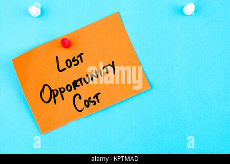 Lost Opportunity Cost written on orange paper note pinned on cork board ...