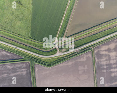 Adjoining the dirt road to the road with asphalt Stock Photo - Alamy