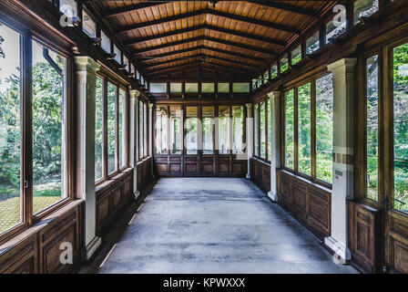 Abandoned house veranda room with view through broken windows and doors ...