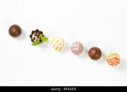 row of chocolate pralines or bonbons on chocolate sprinkles Stock Photo ...