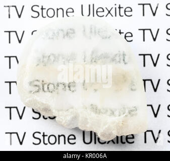 polished Ulexite (TV stone) natural mineral gemstone on sheet of paper ...