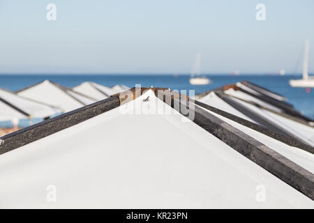 triangular umbrellas on seaside beach for relaxation and sun protection ...