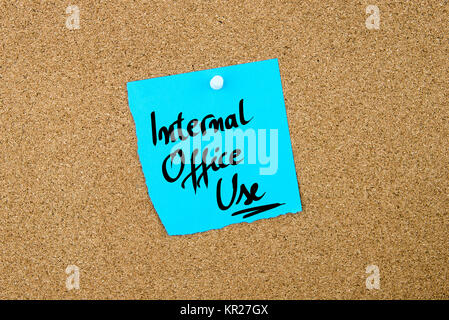 Internal Office Use written on blue paper note pinned on cork board ...
