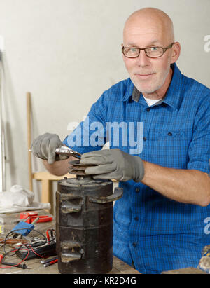 a man with antique generator for the car Stock Photo - Alamy