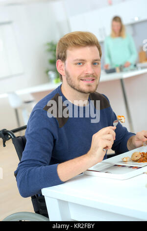 Disabled man eating his lunch Stock Photo - Alamy