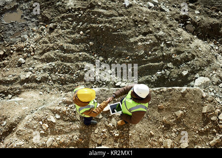 Two quarry workers shaking hands Stock Photo - Alamy