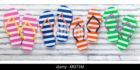 Row colorful flip flops isolated over white background Stock Photo - Alamy