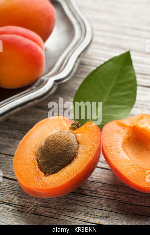 Ripe apricot cross section with juicy yellow flesh with stone closeup ...